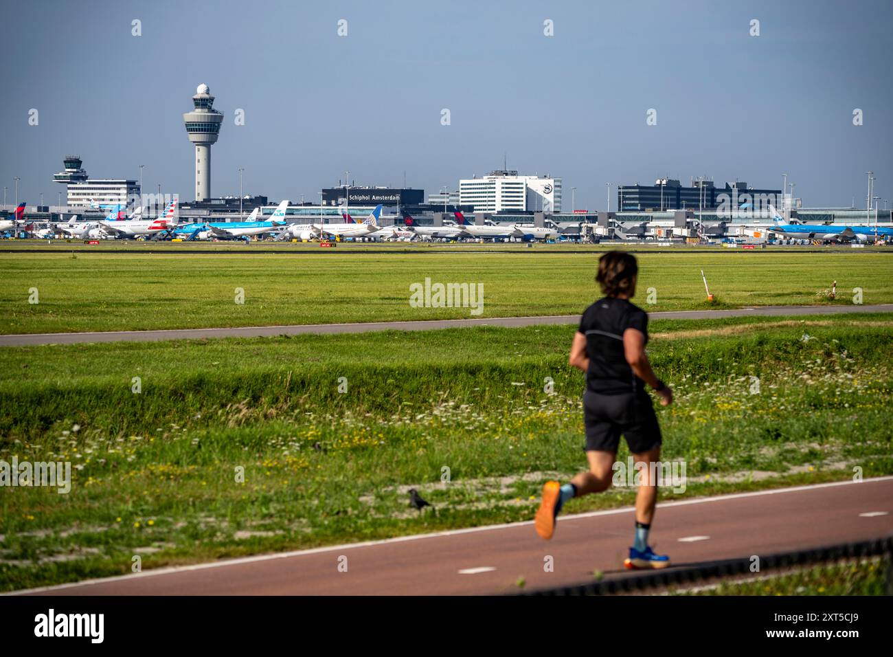 Joggers in front of the airport, airplanes at Amsterdam Schiphol ...