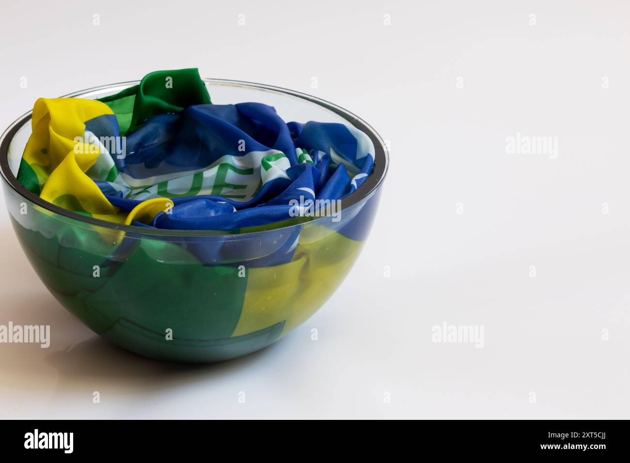 Brazilian flag soaking in water inside a clear glass container with the ...