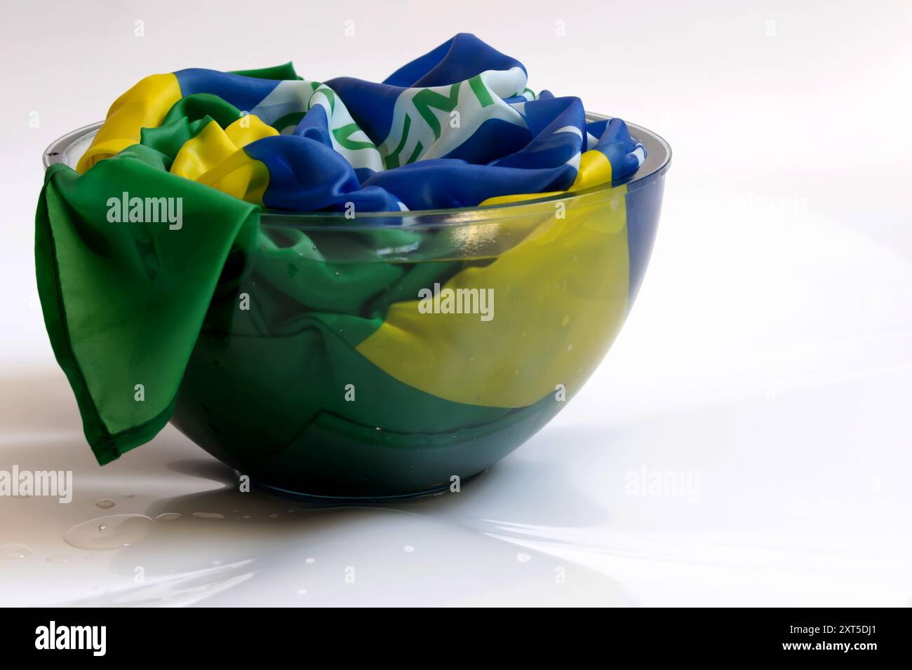 Brazilian flag soaking in water inside a glass container with the tip ...