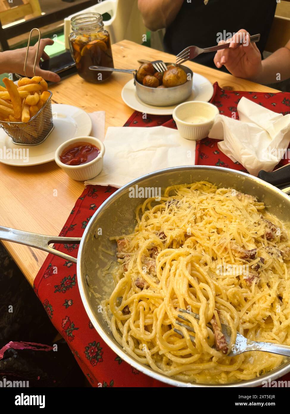 friends have lunch at a restaurant with spaghetti and French fries ...