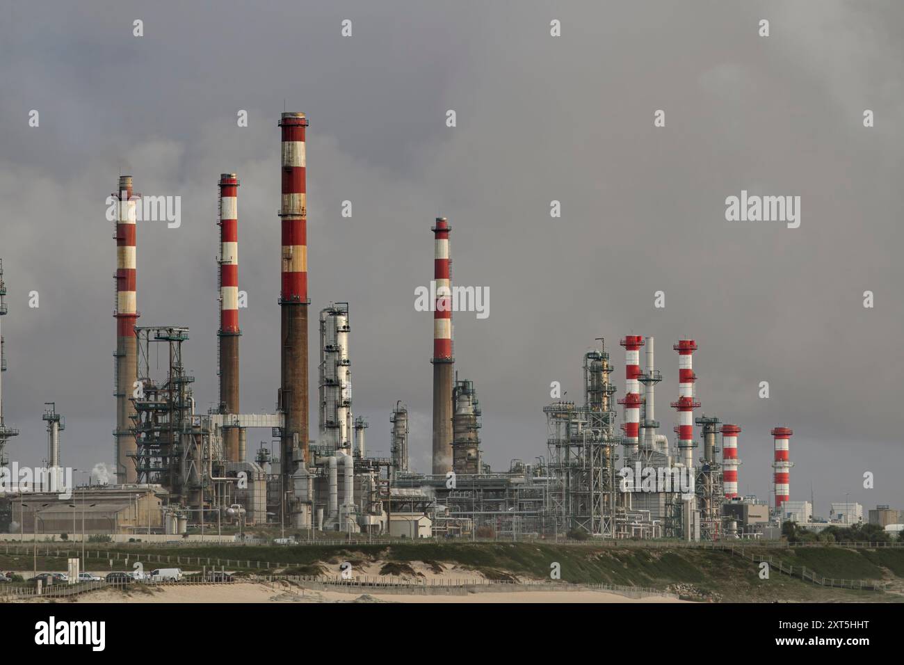 Oil refinery by the sea before rain. Late evening light Stock Photo - Alamy