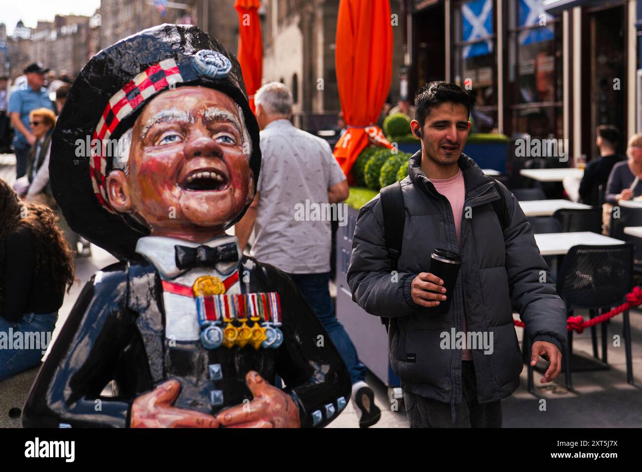 Tourists in Edinburgh taking in views, posing for photos, takin in the ...
