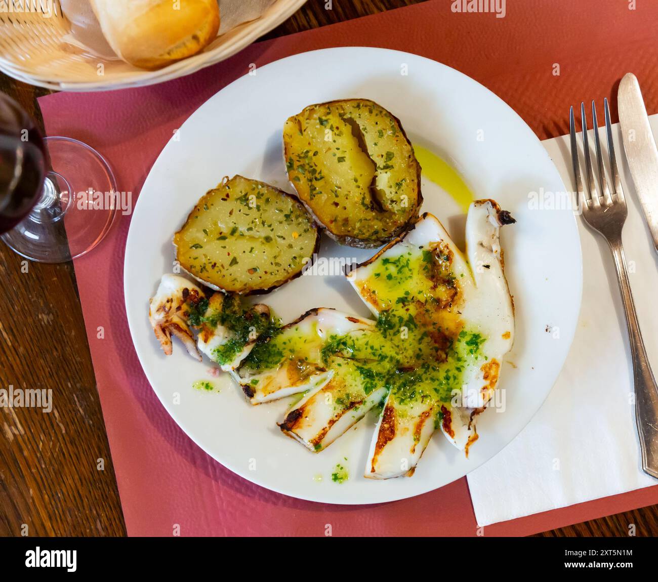 Grilled cuttlefish served with garlic and parsley Stock Photo - Alamy