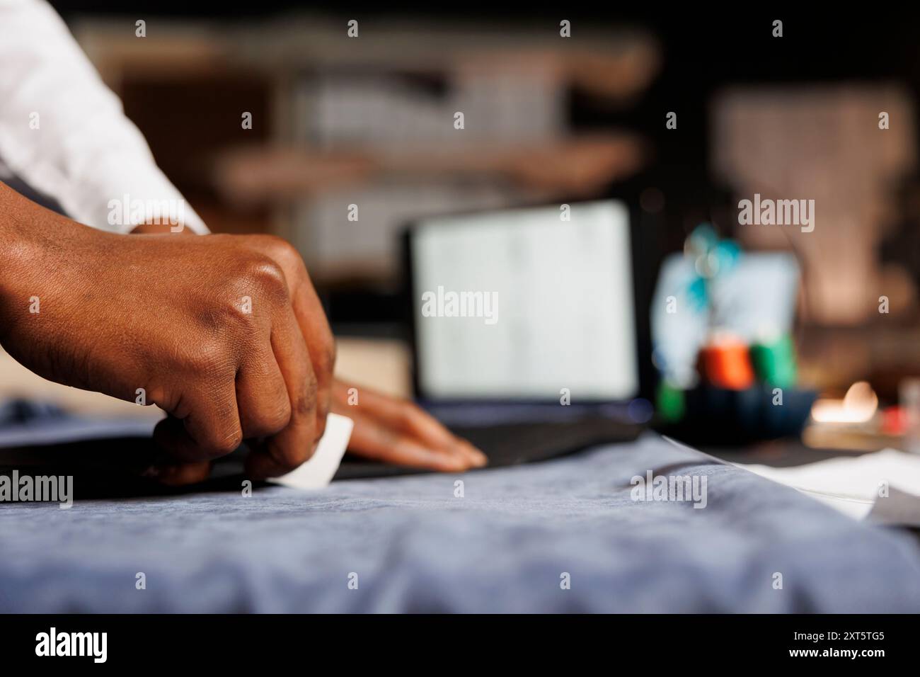 Extreme close up of african american suitmaker meticulously checking ...