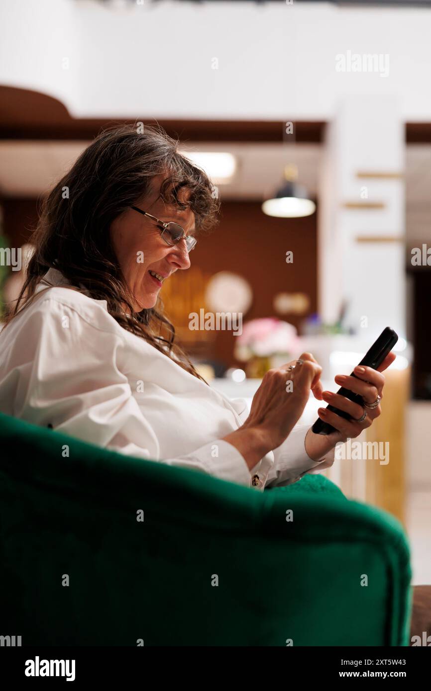 Hotel receptionist holding smartphone hi-res stock photography and ...