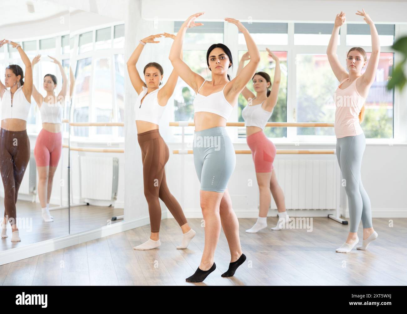 Young female ballet dancer executing dance moves with focused precision ...