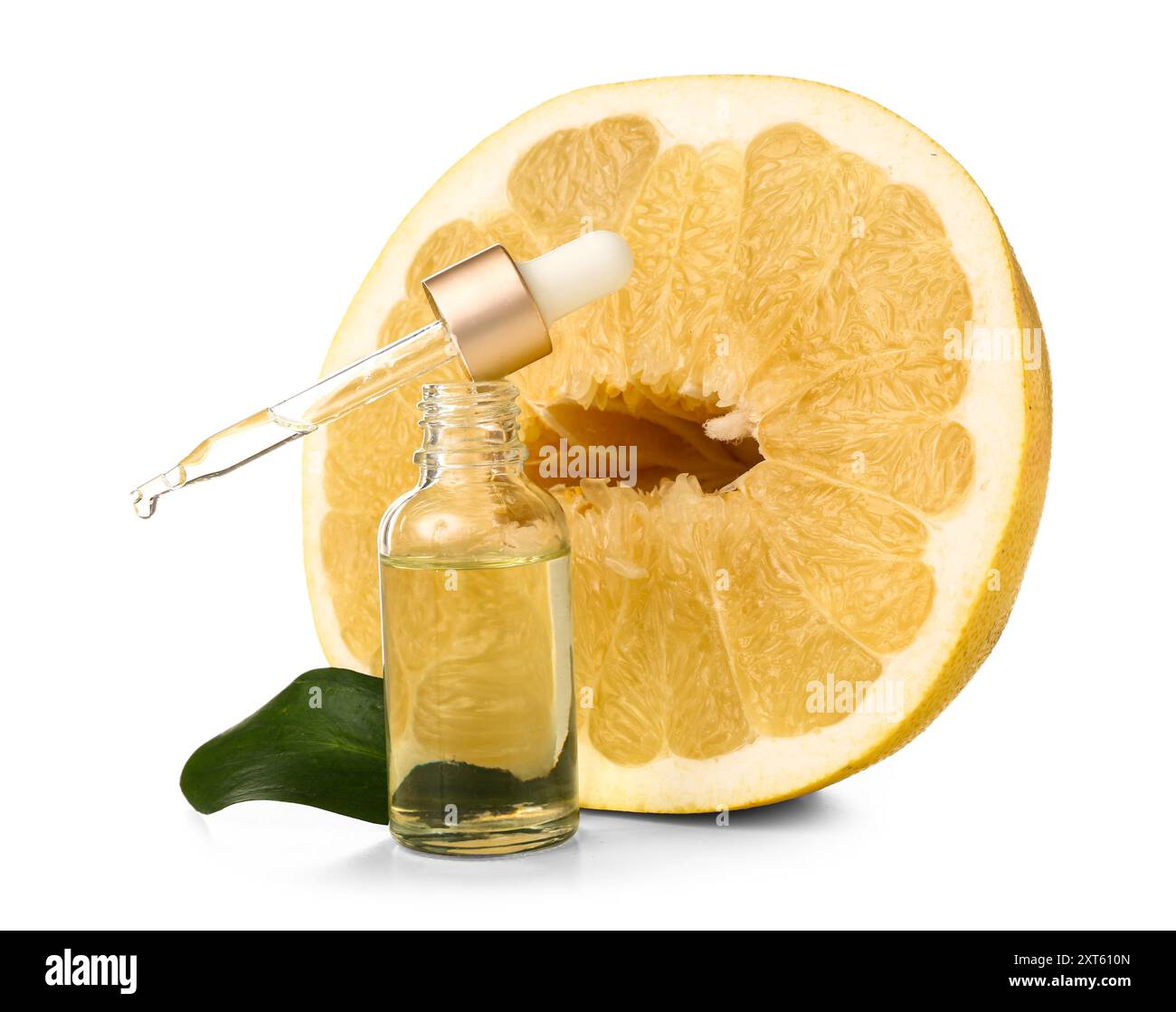 Half of juicy pomelo and bottle of cosmetic oil on white background ...