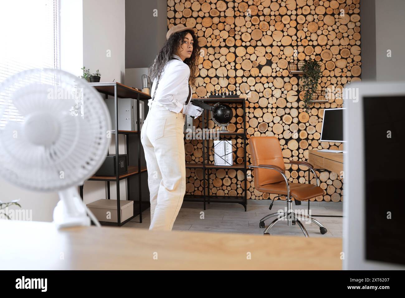 Female African-American spy with gun in office Stock Photo - Alamy