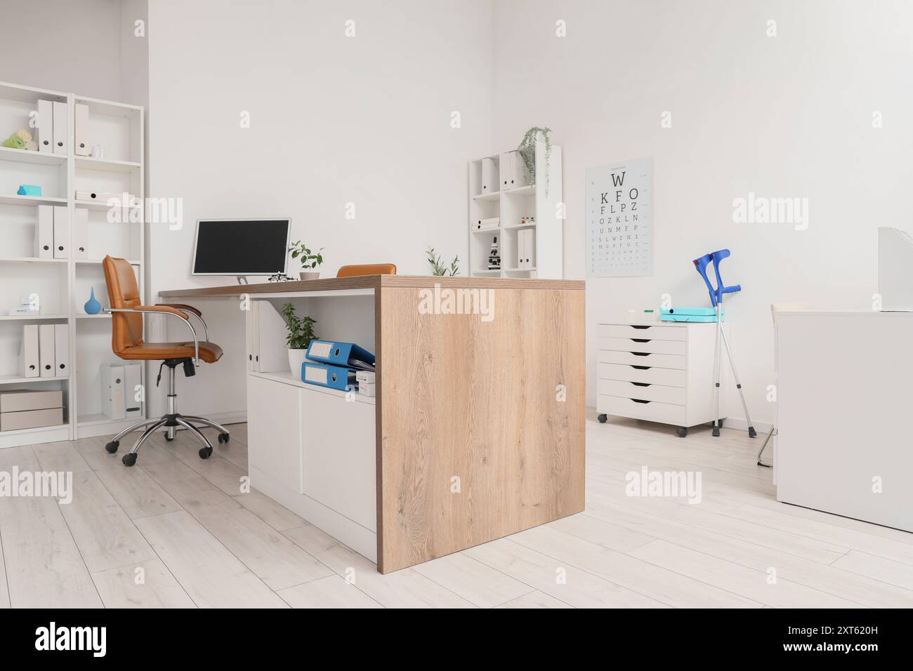 Interior of medical office with doctor's workplace, shelf units and eye ...