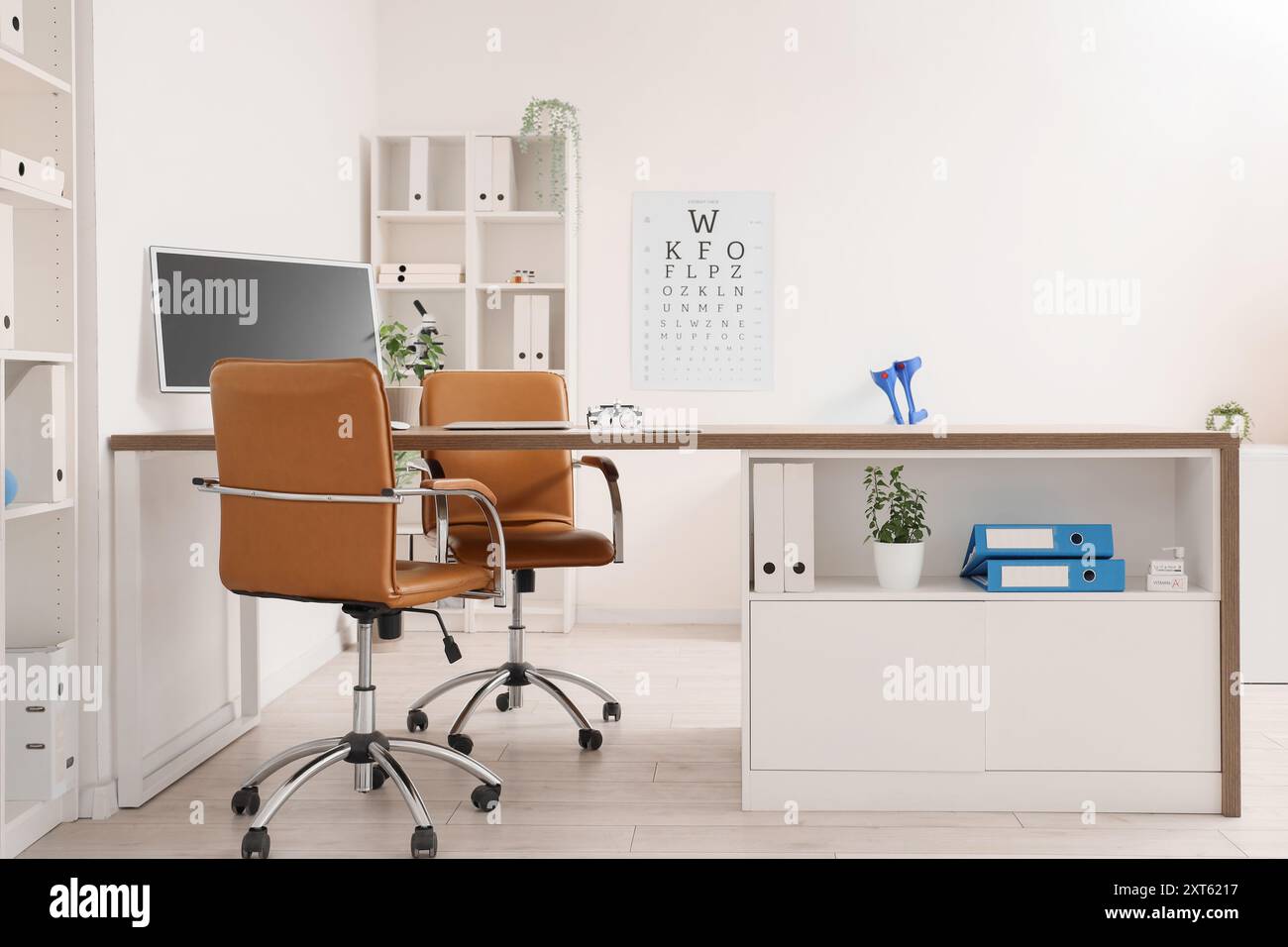 Interior of medical office with doctor's workplace and eye test chart ...
