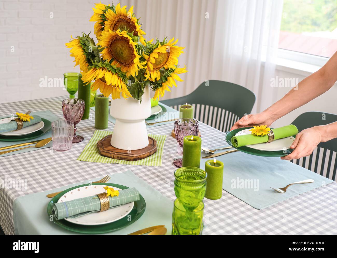 Female hands serving dining table in room Stock Photo - Alamy