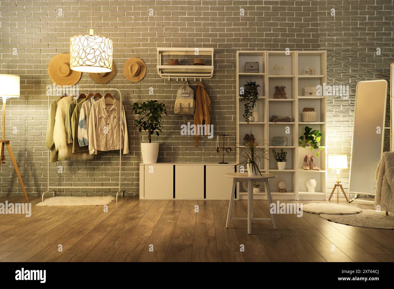 Interior of hall with glowing lamps, clothes rack and shelf unit in ...