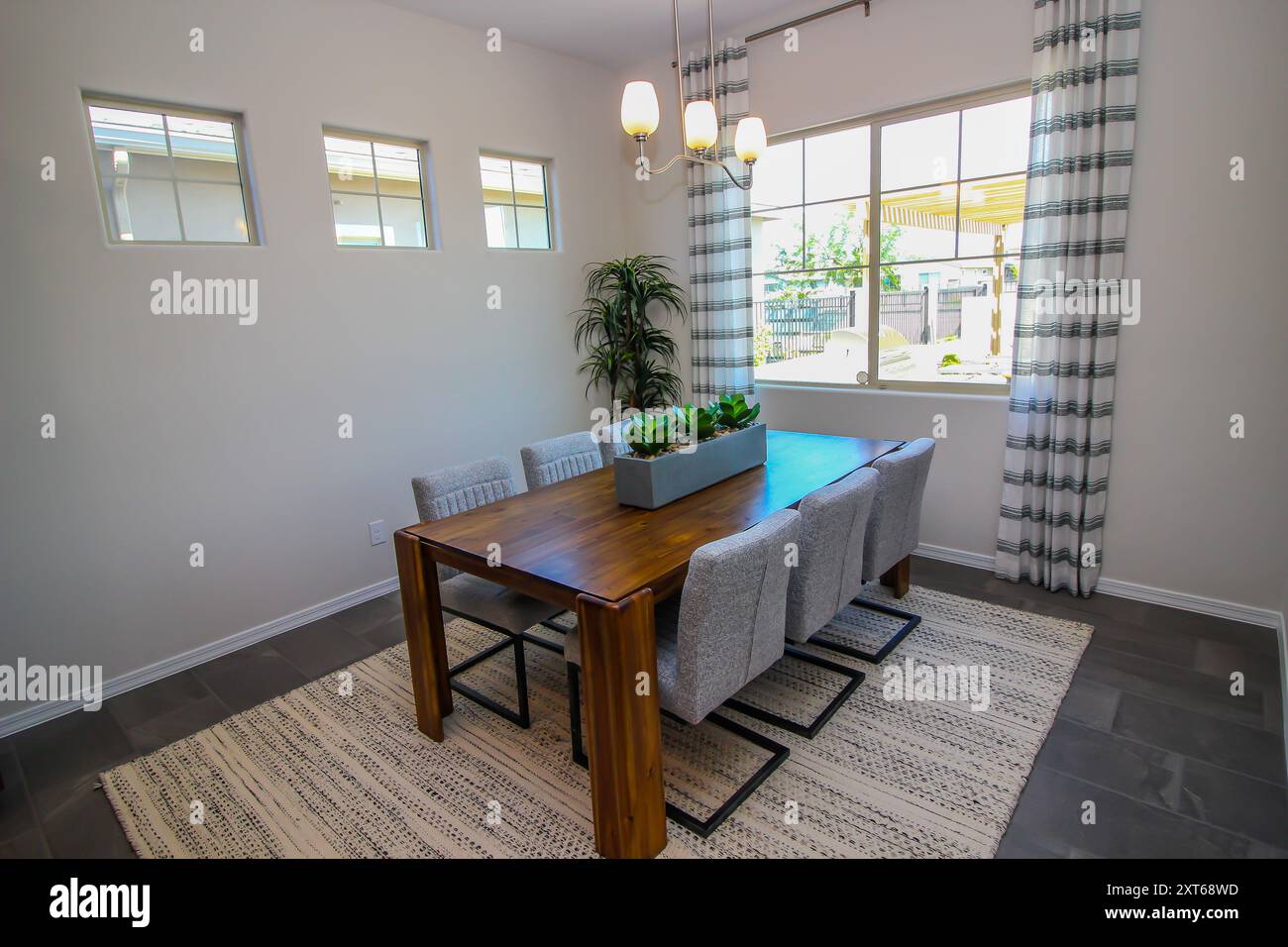 Dining Area With Oblong Wooden Table And Centerpiece Stock Photo - Alamy