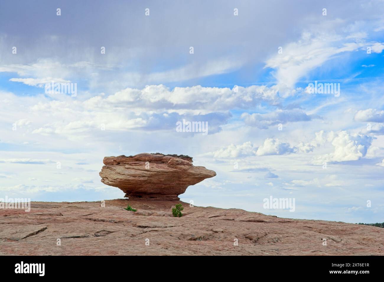 Weathered sandstone formation stand beneath dynamic cloud filled sky Stock Photo - Alamy
