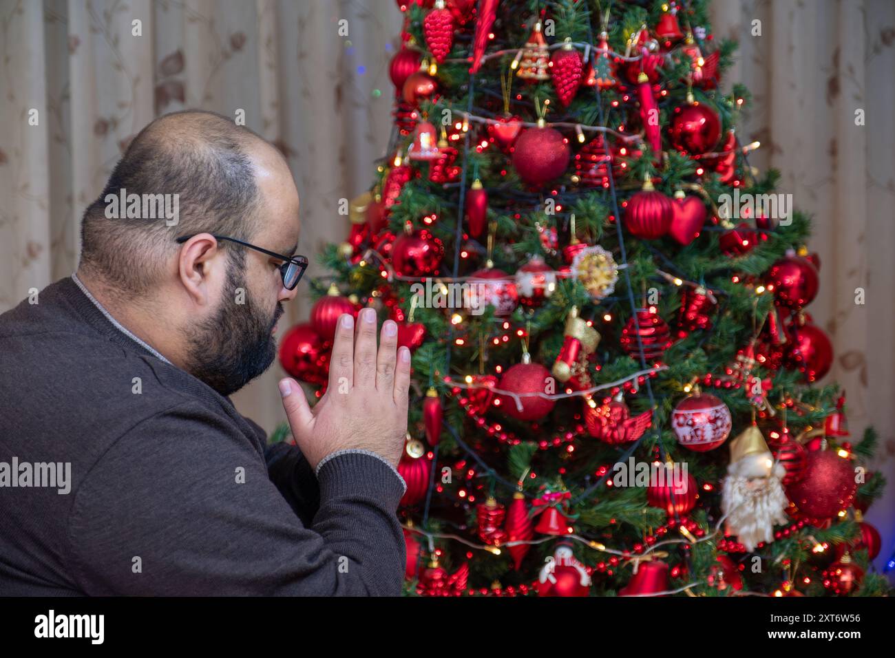 A man in deep reflection with clasped hands beside a beautifully ...