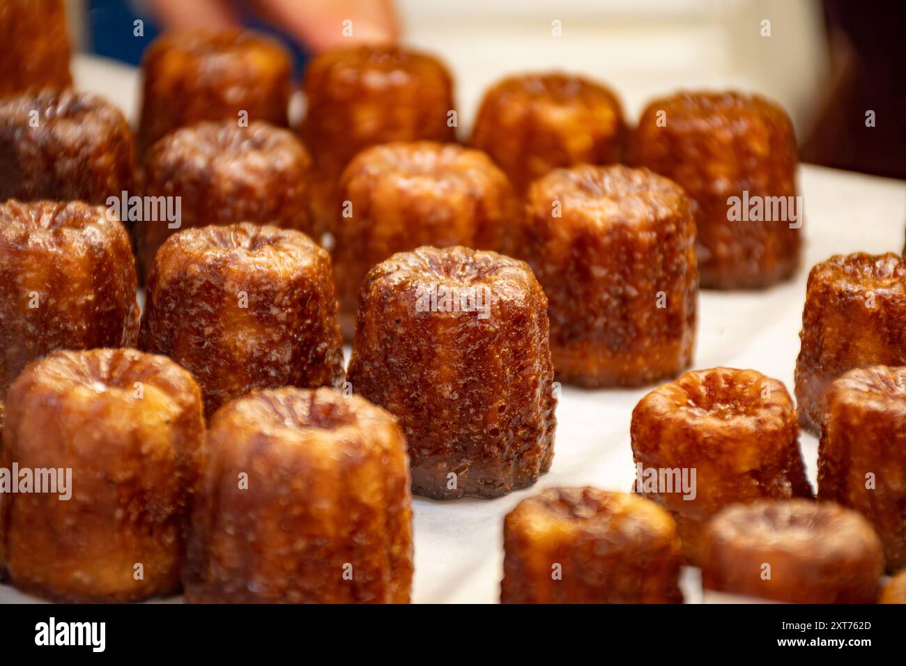 Baked Canele, French pastry flavored with rum and vanilla, specialty of ...
