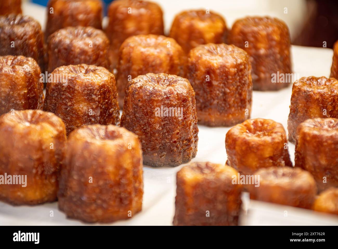 Baked Canele, French pastry flavored with rum and vanilla, specialty of ...