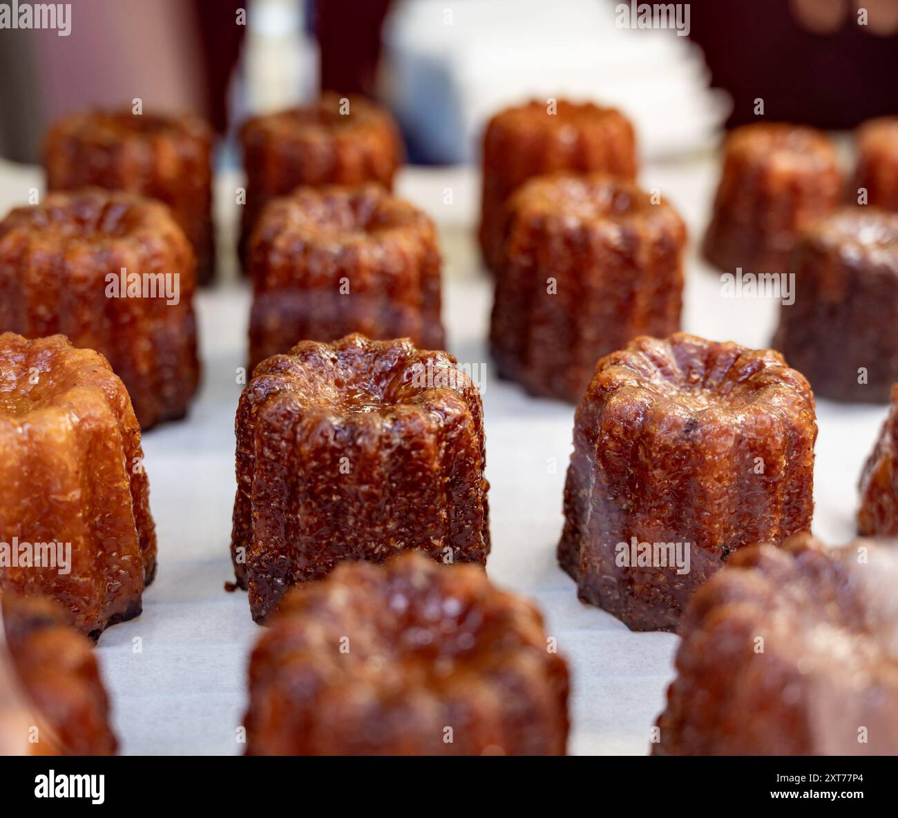 Baked Canele, French pastry flavored with rum and vanilla, specialty of ...