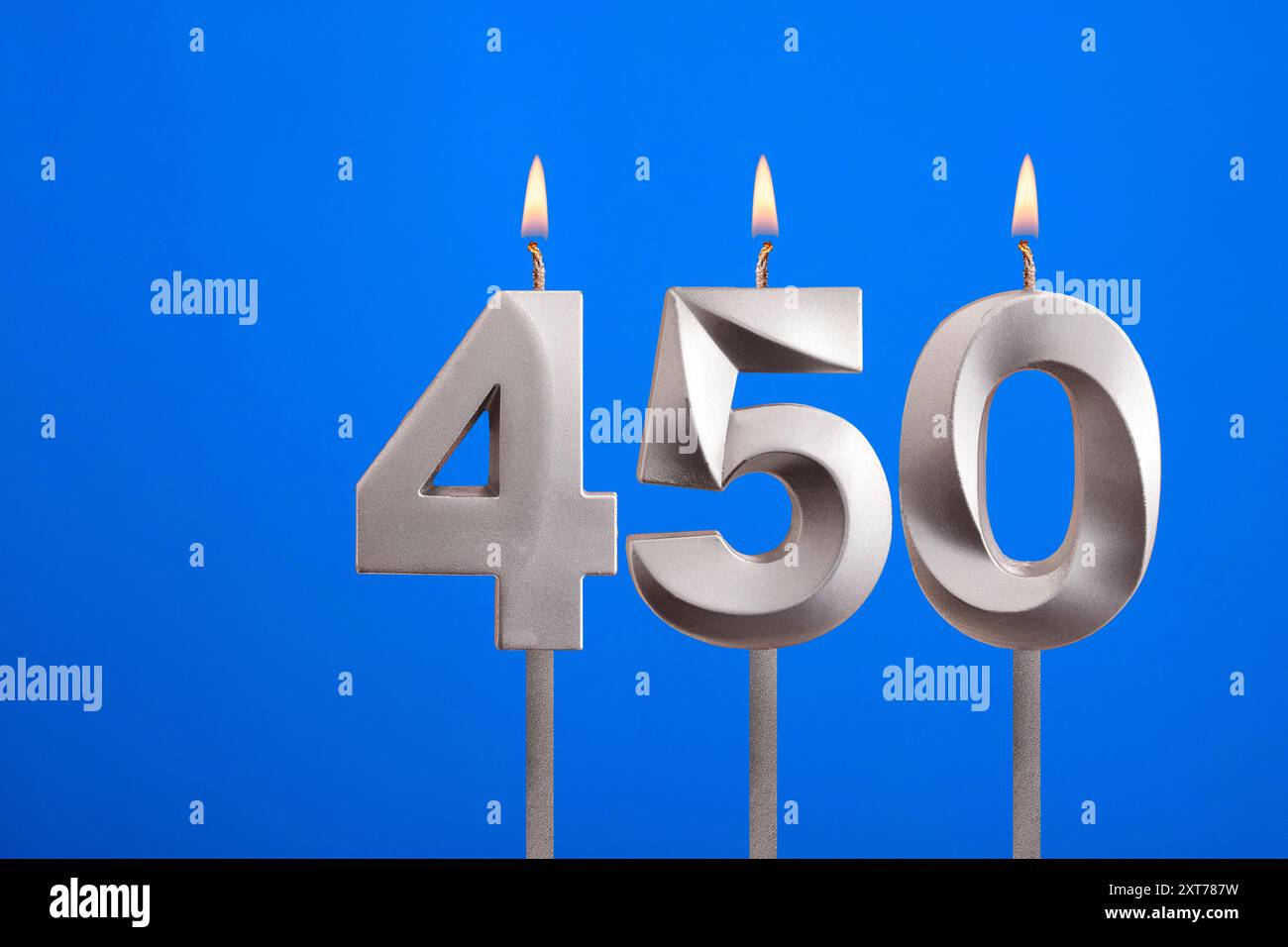 Birthday number 450 - Candle lit on blue background Stock Photo - Alamy