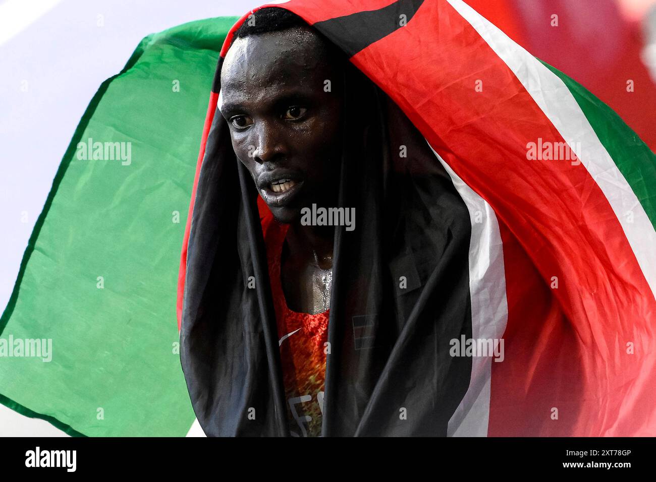 Edwin Kurgat of Kenya with a national flag after competing in the men's ...