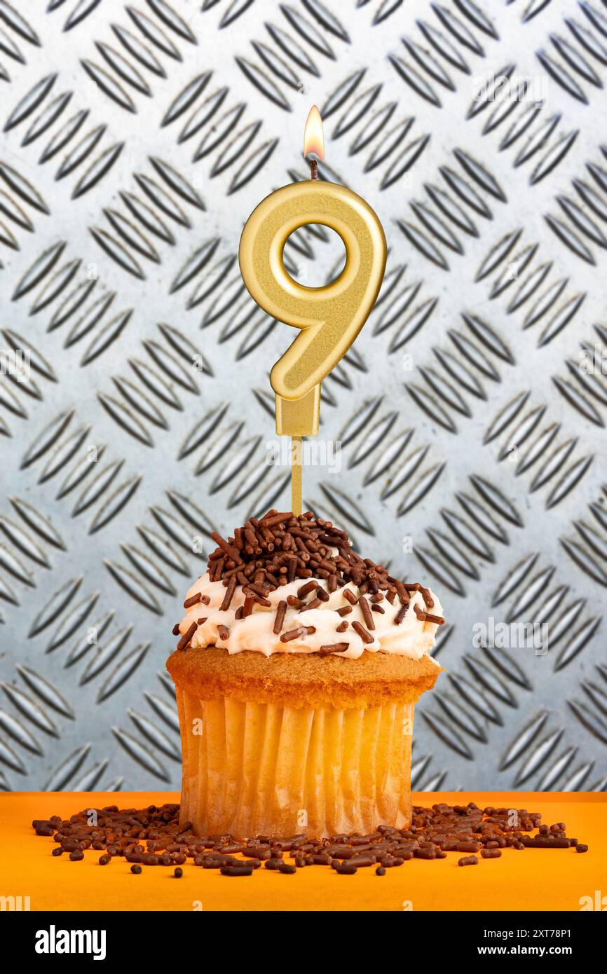 Chocolate cupcake with candle number 9 - Birthday on industrial ...