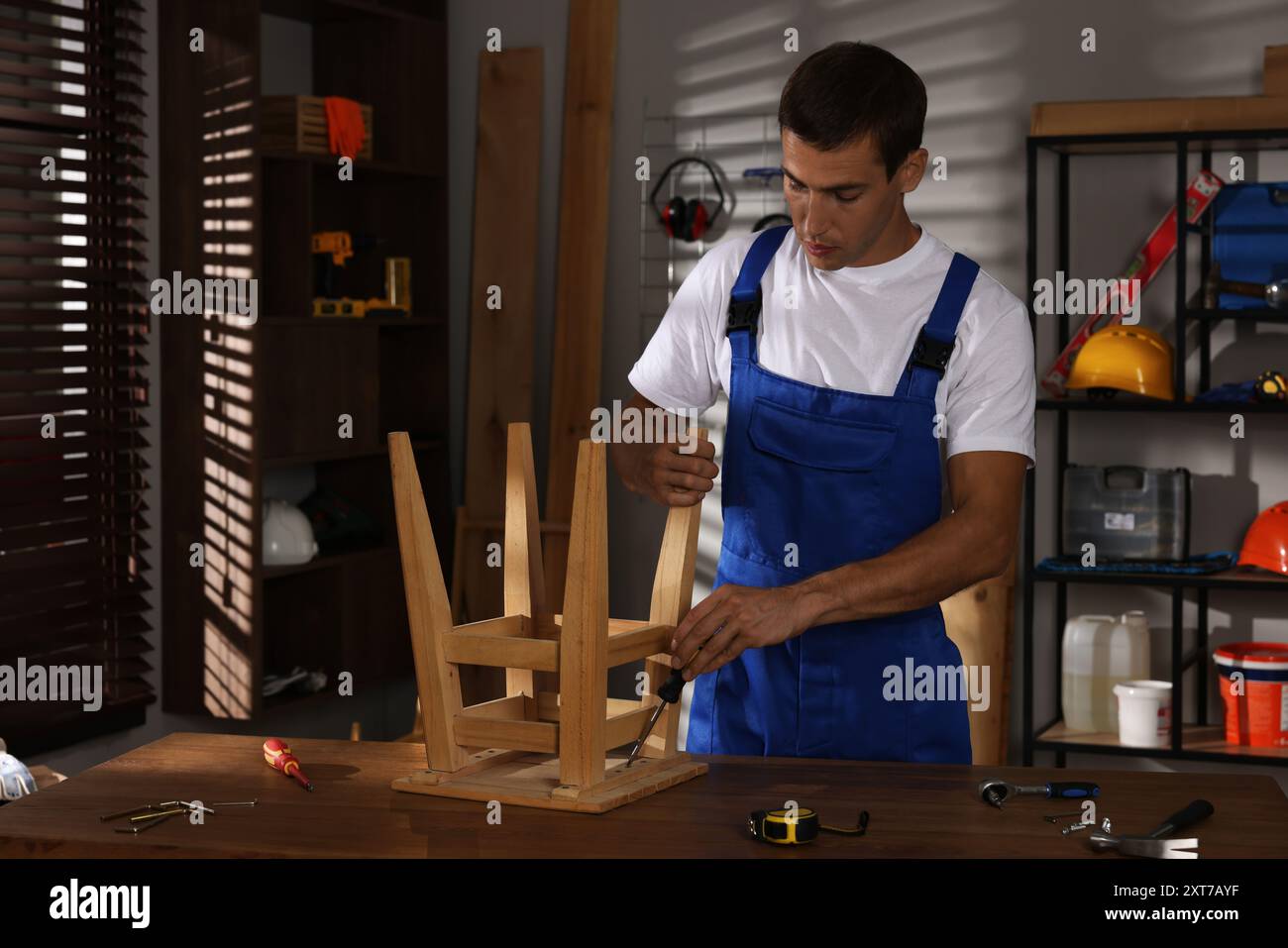 Man repairing wooden stool hi-res stock photography and images - Alamy