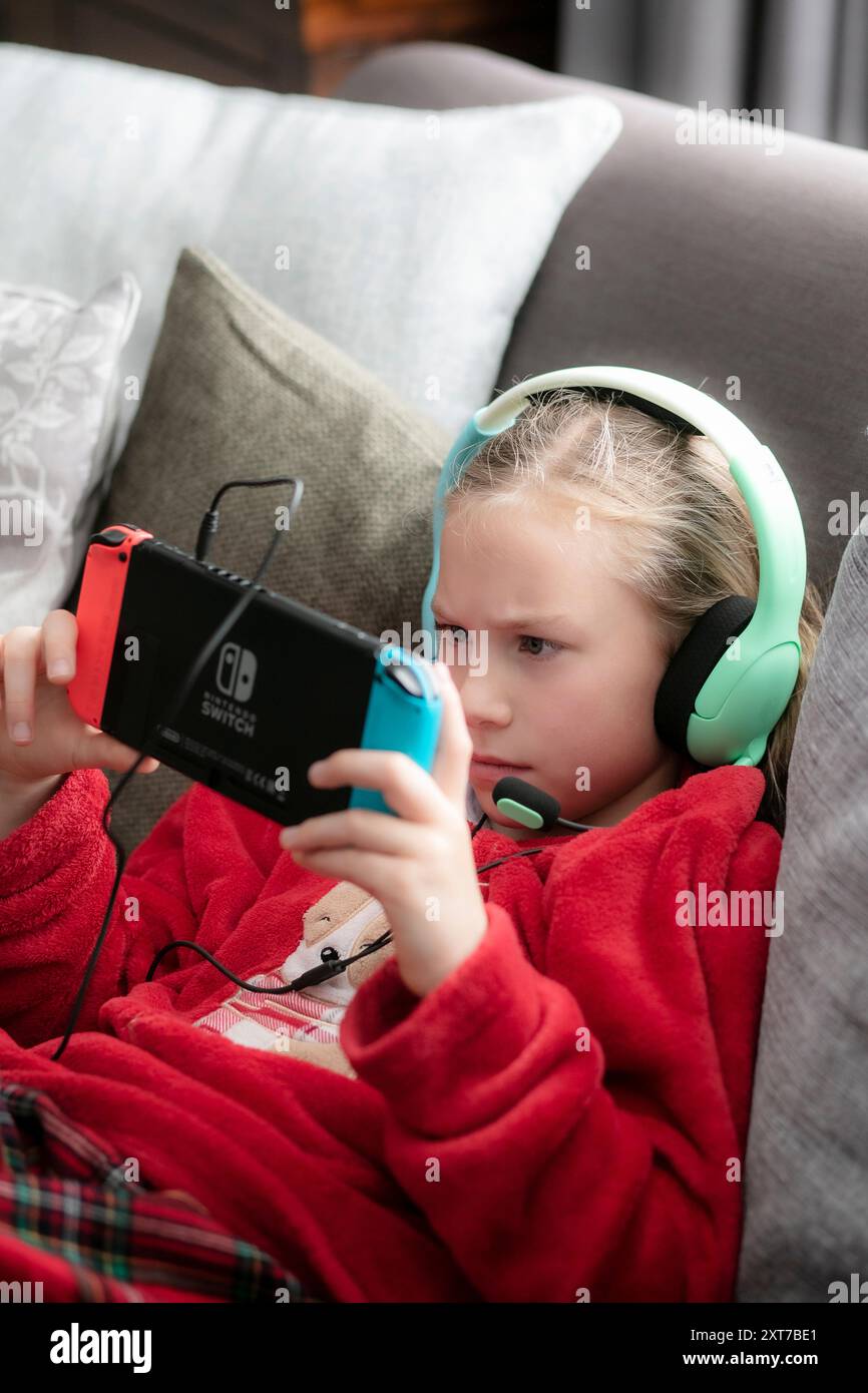 Girl playing on a portable gaming console Stock Photo - Alamy