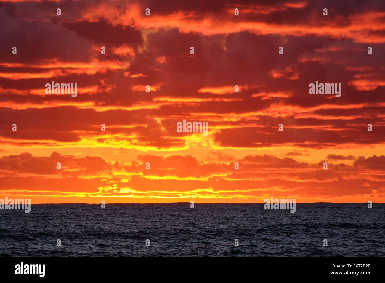 A fiery red and yellow sunset over the Indian Ocean as seen from just ...