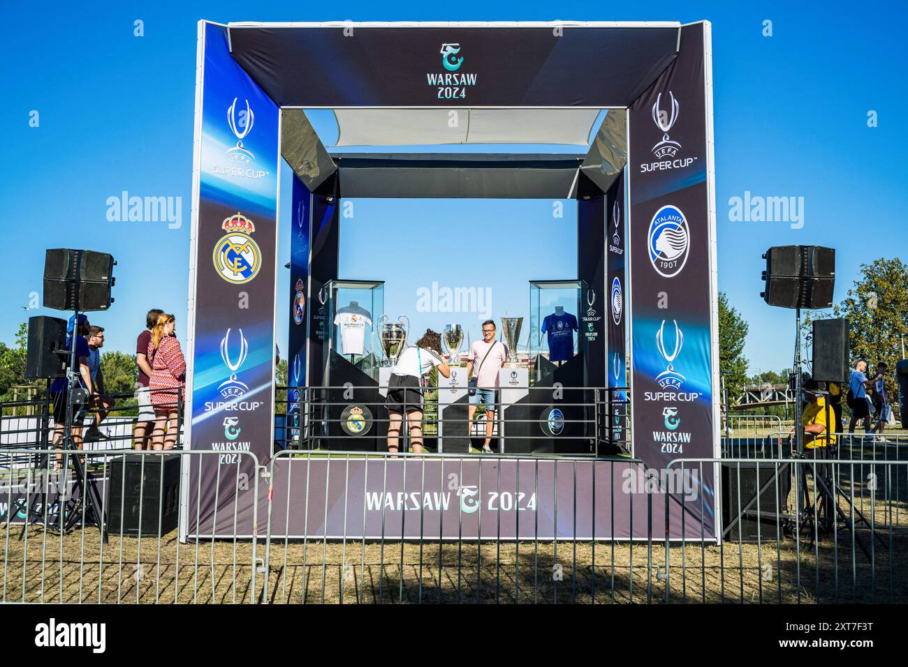 Visitors queue to have their photograph taken beside the UEFA Cup, the ...