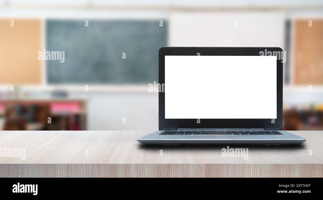 Laptop on table in modern office with school background. Cropped shot ...