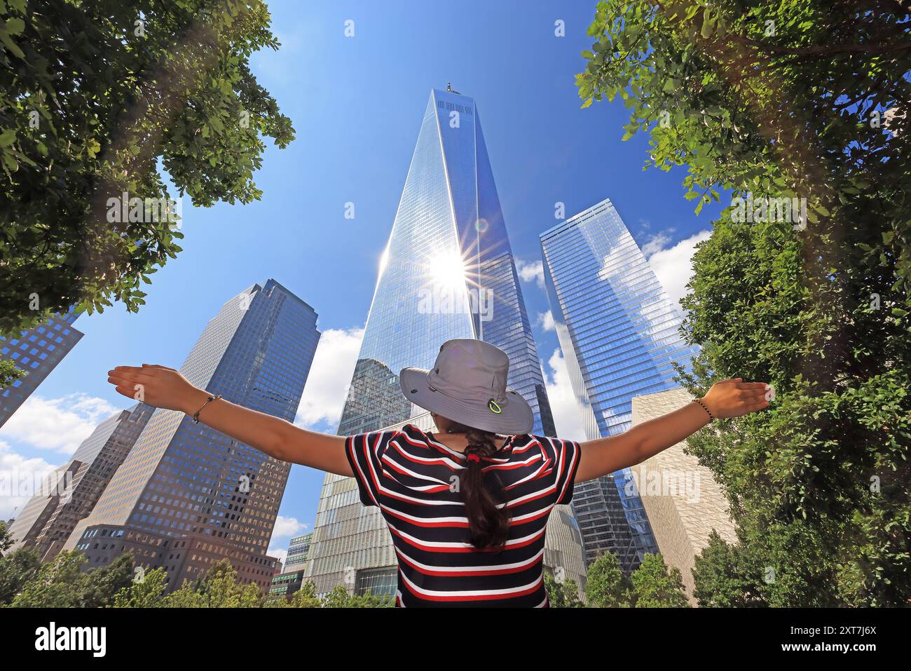 Teenager girl tourist admiring the Freedom Tower. Freedom Tower and Memorial Fountain ...