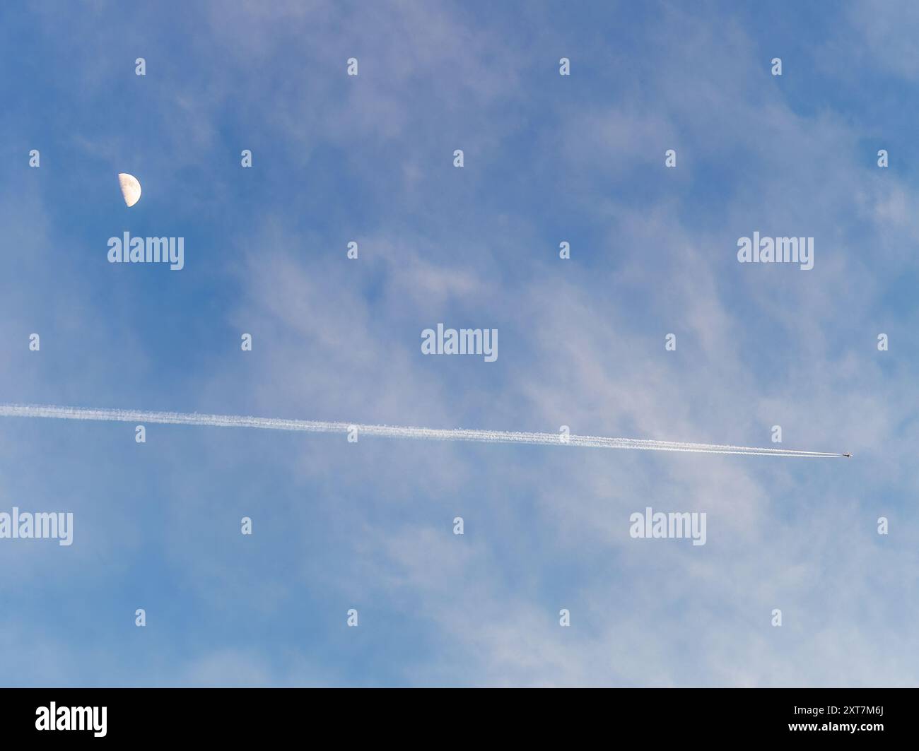 Plane flies pass over the moon on blue sky airplane trail. Amazing ...