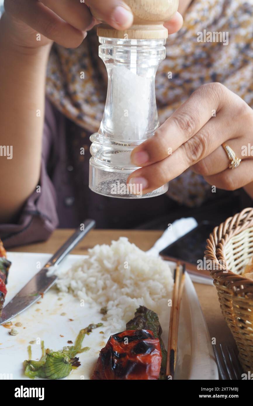 Salt falls from a salt shaker Stock Photo - Alamy