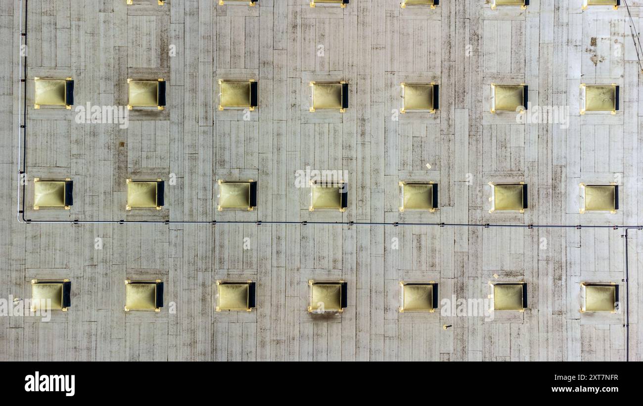 Aerial view of an industrial flat roof with multiple skylights in ...