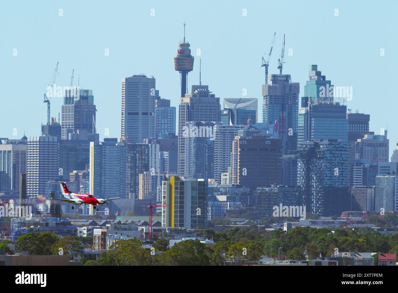 An Air Ambulance Service of NSW aircraft with the skyline of Sydney ...