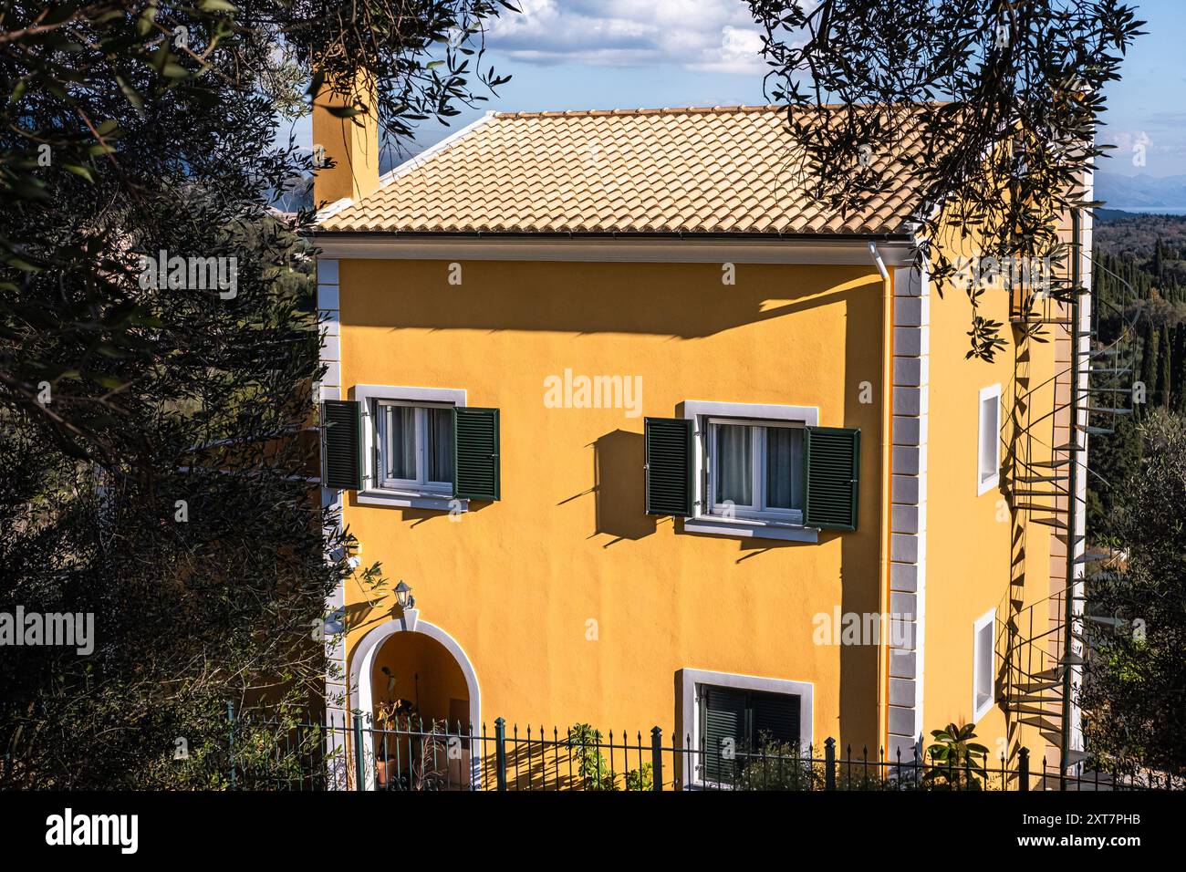 Vintage traditional yellow stone house in a small town in Corfu Island ...
