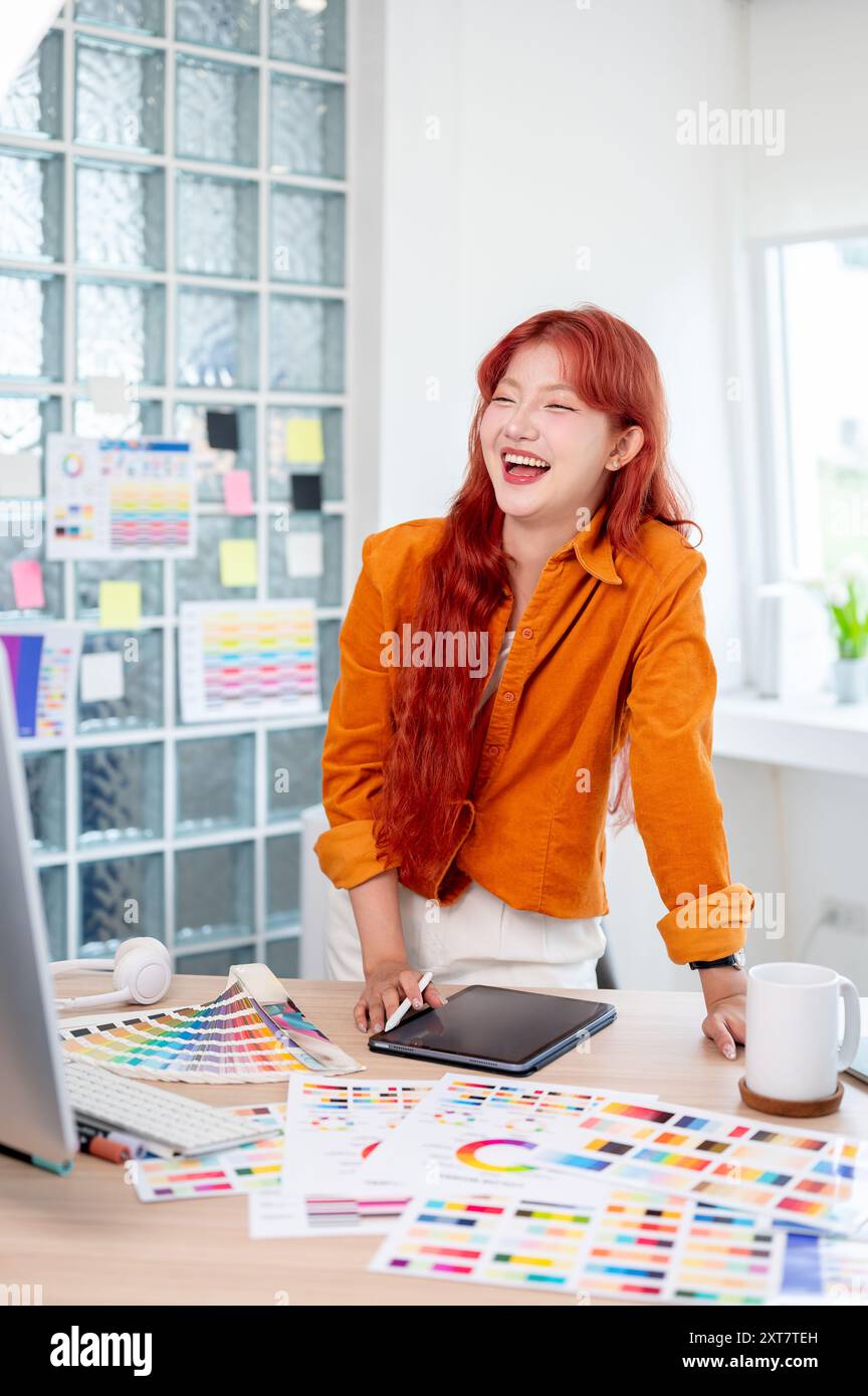 Talented female designer standing using hi-res stock photography and ...