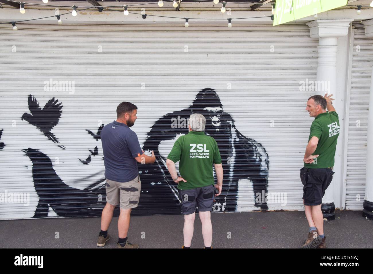 London, UK. 13th August 2024. Zoo staff inspect the new artwork by ...
