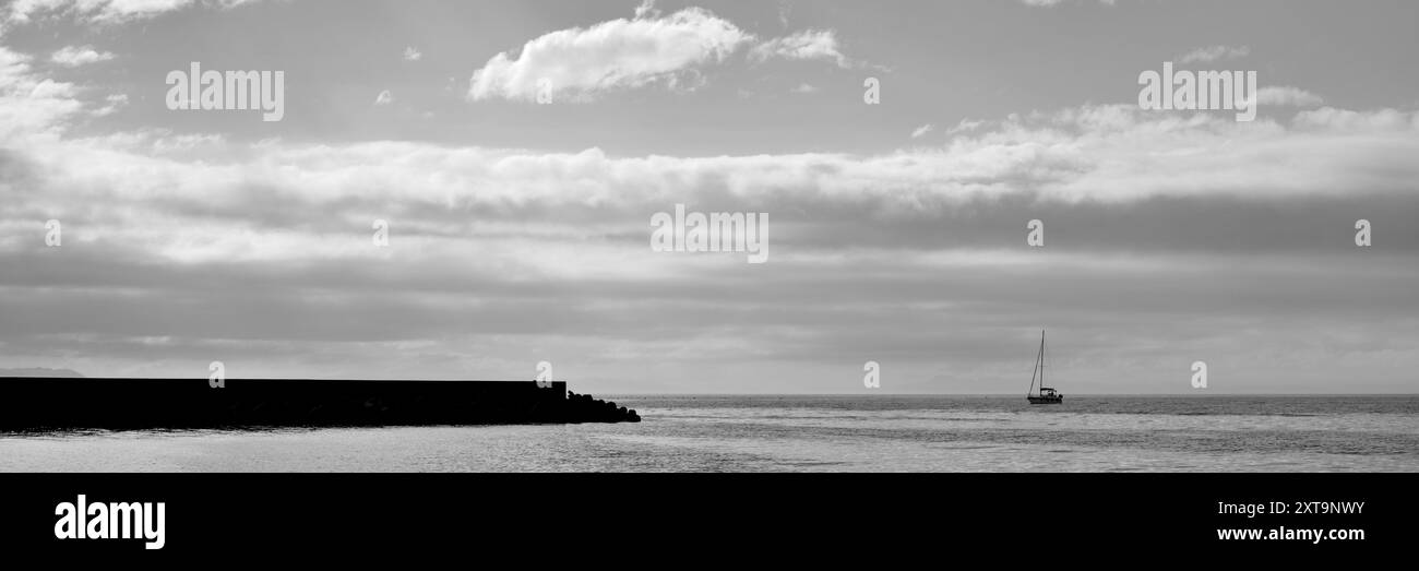 Panoramic black and white image, view of the Osaka Bay during sunset at ...