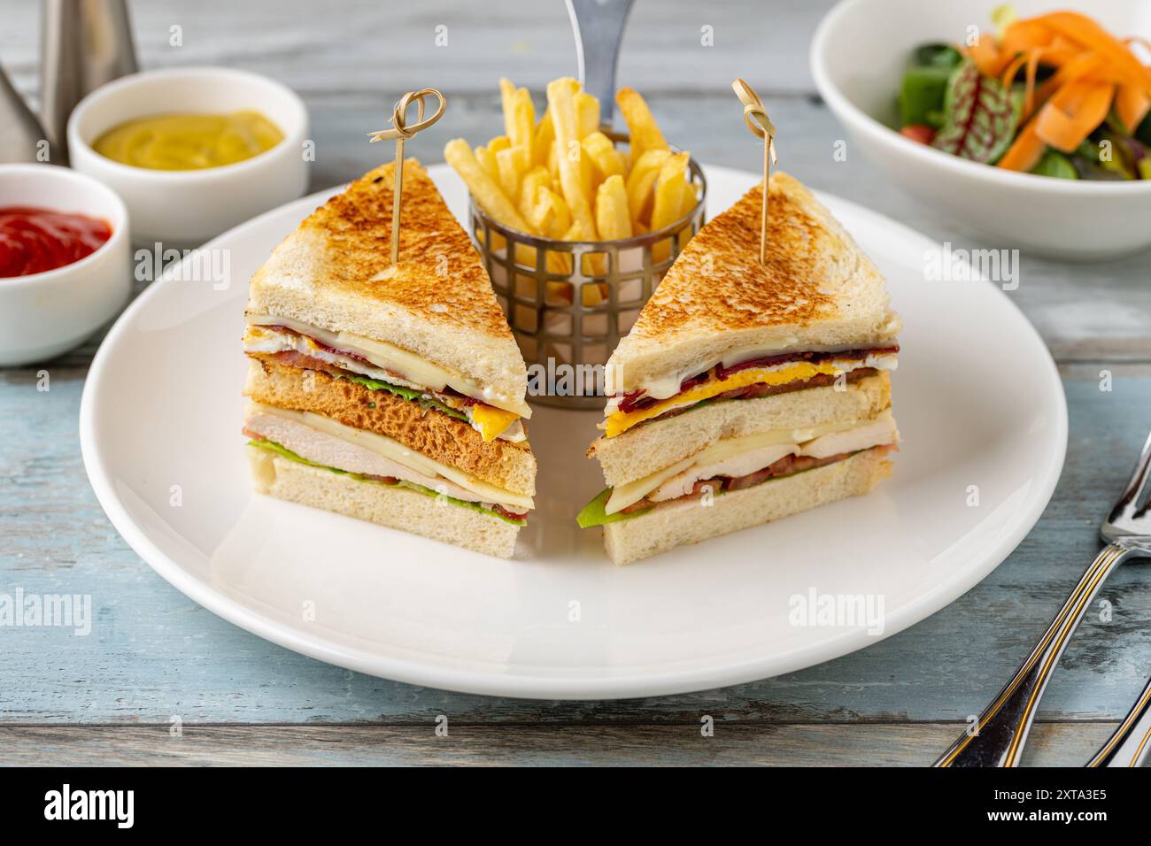 Chicken club sandwich with fries, ketchup, mustard and mayonnaise Stock ...