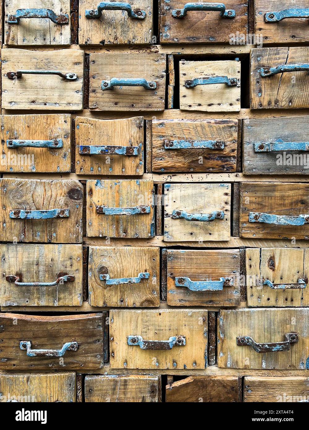 Front image of antique storage drawers in wood material, with metal ...