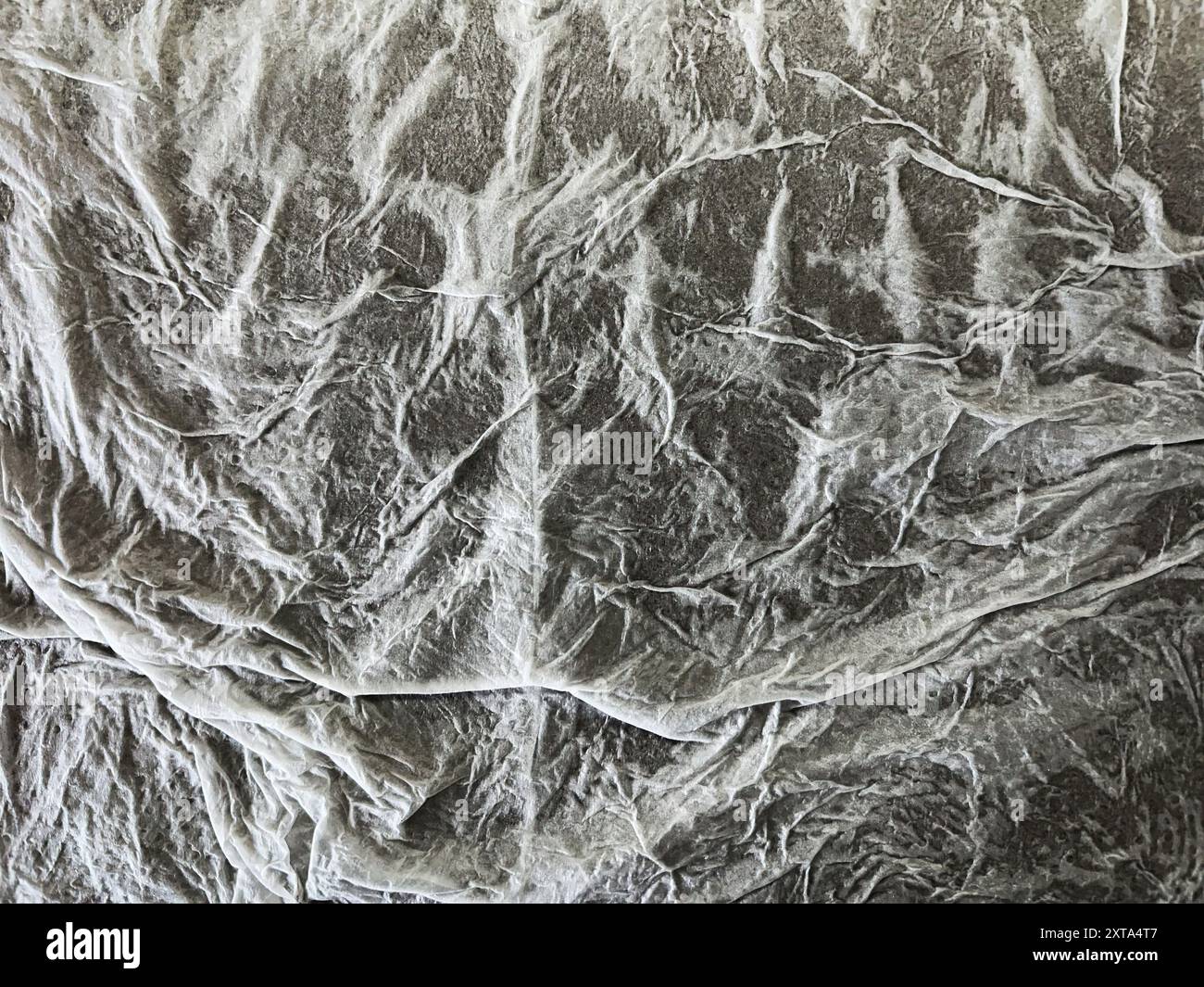 Close up and top view of wet and wrinkled white paper with a lot of ...