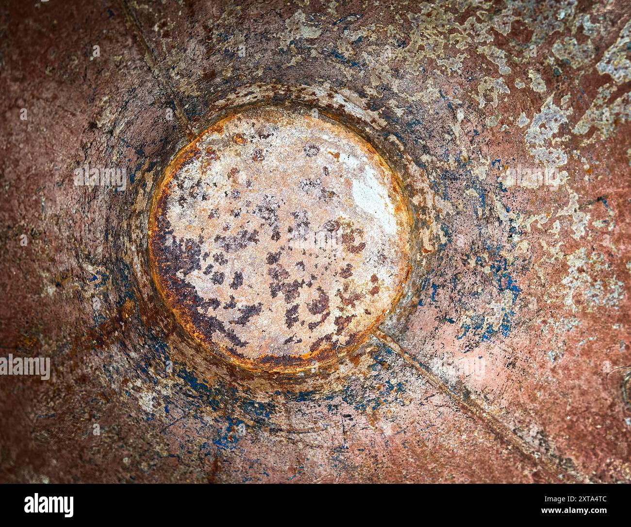 Interior of a large metallic and oxide-aged cube with a circular ...