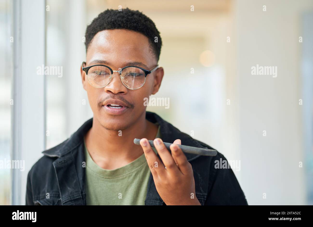 Black man, business and talking on speaker with phone for audio message ...