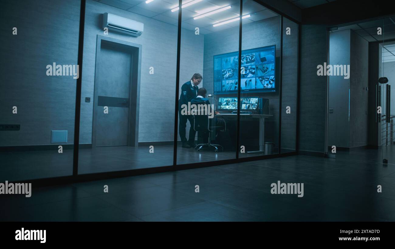 Female security worker have discussion with colleague in monitoring ...