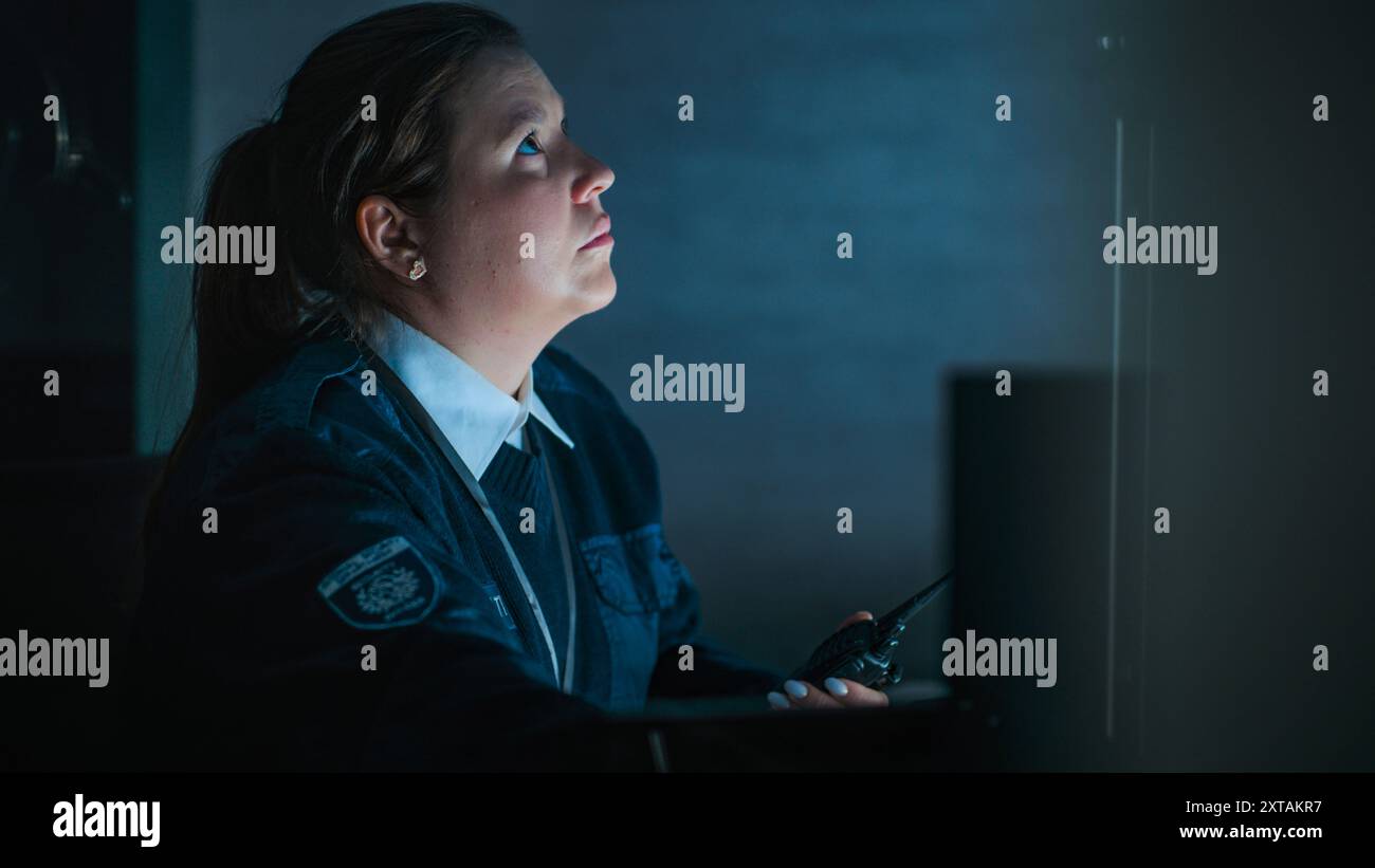 Female security officer or dispatch in uniform uses walkie talkie ...