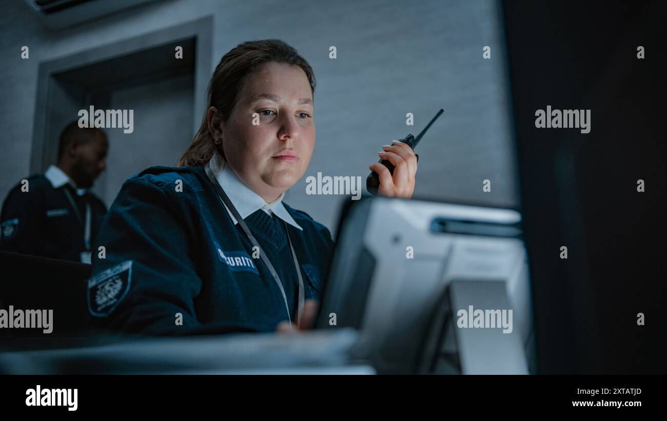Female security officer or dispatch in uniform talks in walkie talkie ...