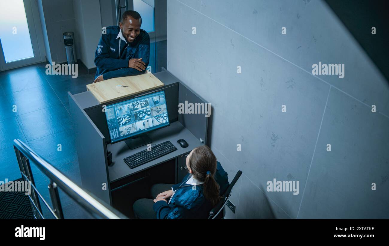 Caucasian female security guard sits at the workplace in the office ...