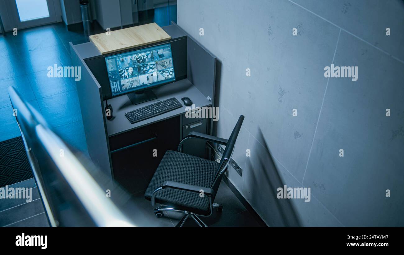 High angle of the workplace for security guard with PC at the entrance ...