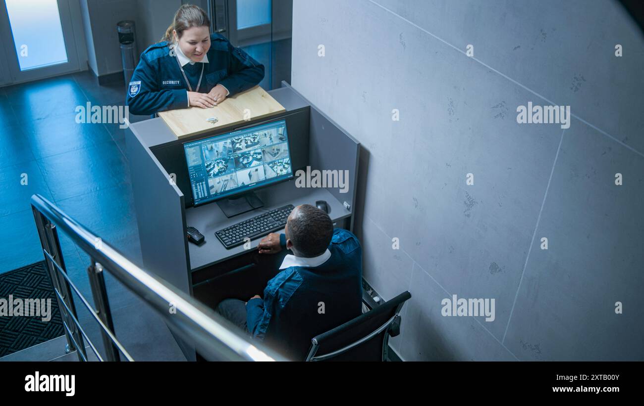 African American male security guard sits at the workplace in the ...